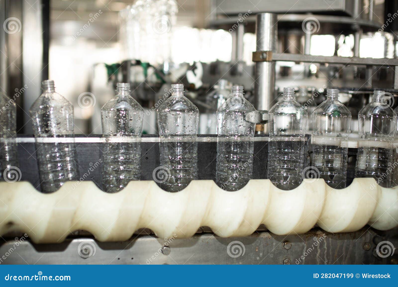 Row of Plastic Bottles Being Filled with Liquid Stock Image - Image of ...