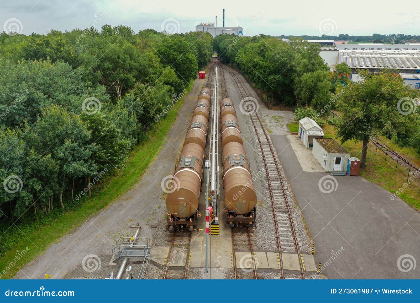 Row of Railway Carriages Parked on a Track in an Industrial Setting ...
