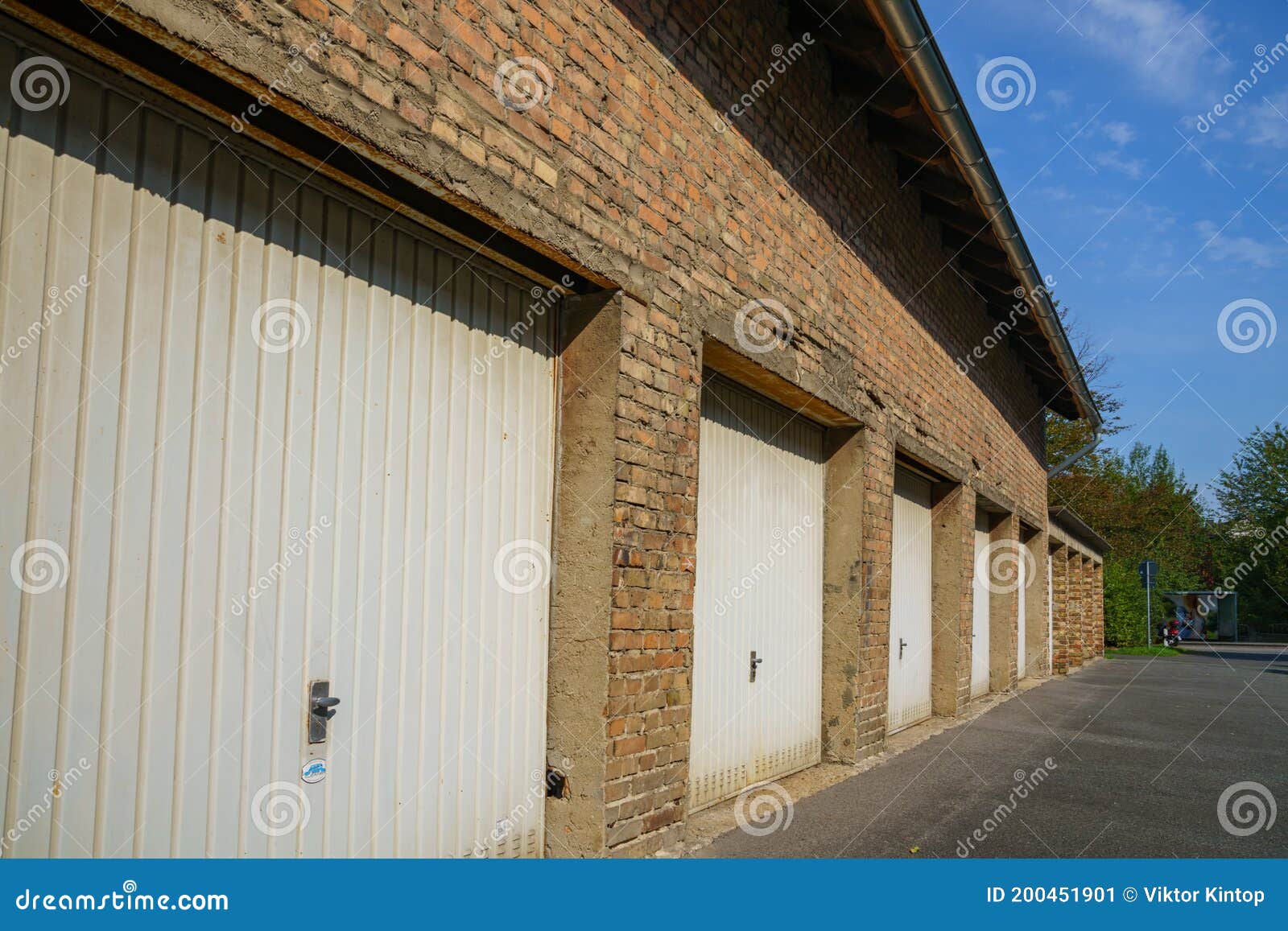 A Row of Red Brick Garages with Closed Gates Stock Image - Image of ...