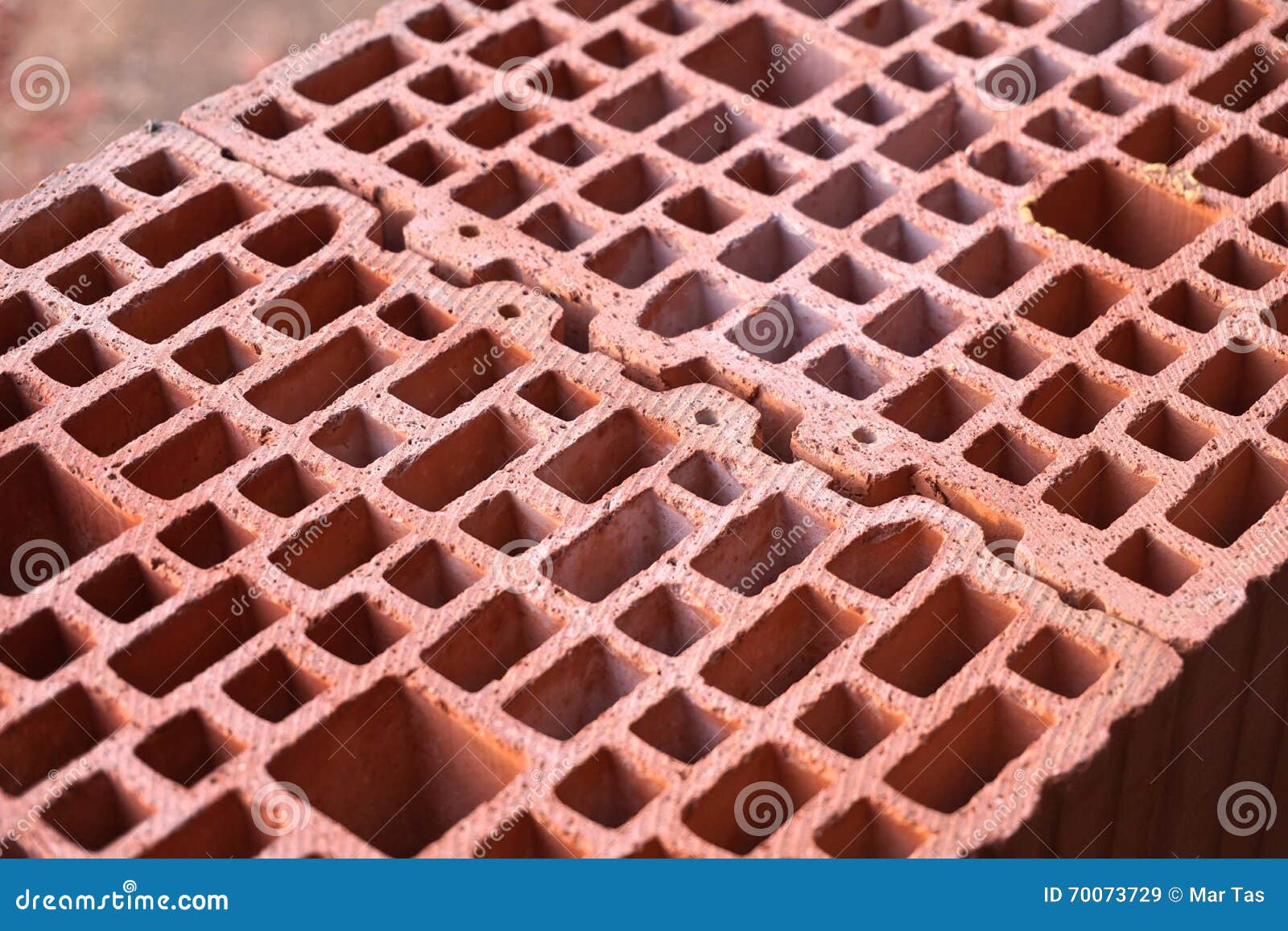 Row of Red Bricks with the Holes in the Shape of Honeycomb on the ...