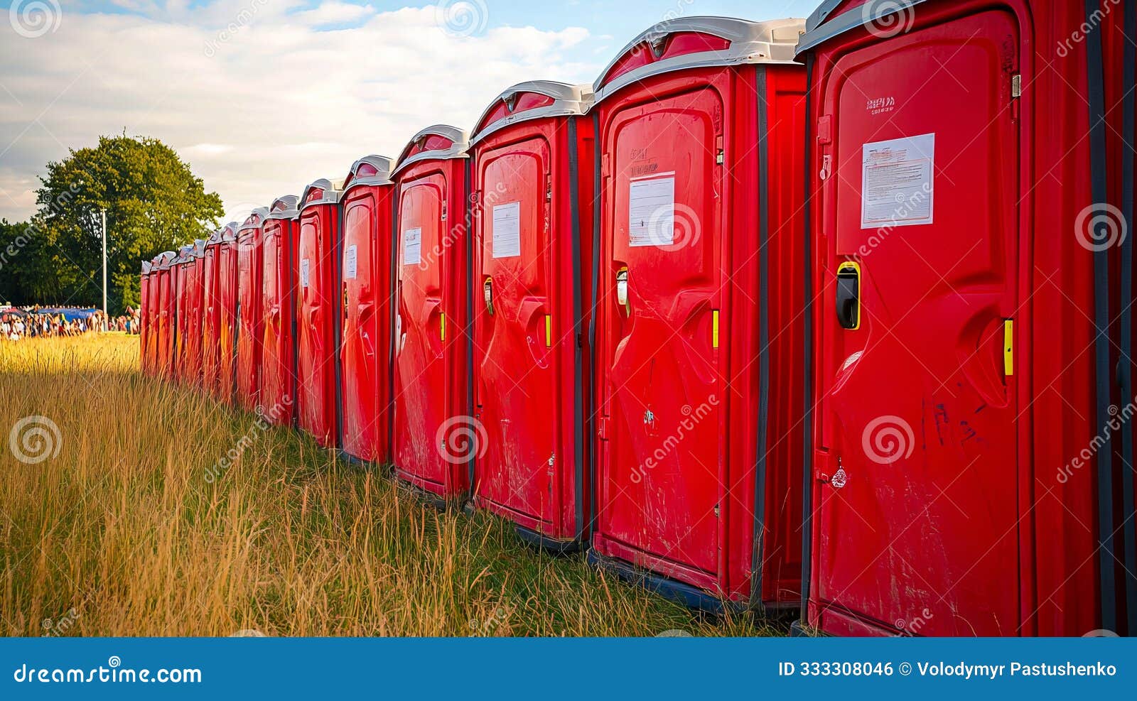 A Row of Red Portable Toilets Lined Up in a Field Stock Photo - Image ...