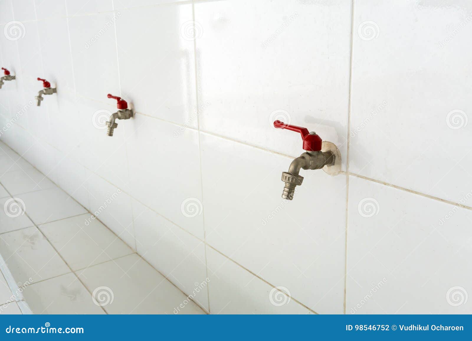 Row of Red Water Taps Against White Wall Stock Photo - Image of long ...