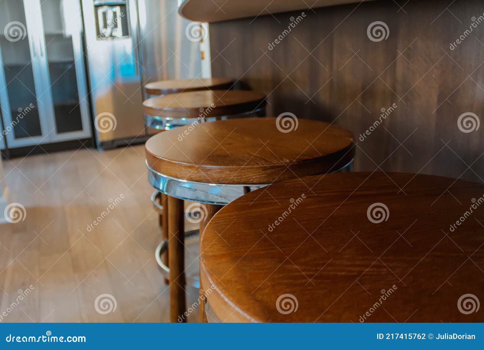 Row of Retro Wooden Stools in Front of Wooden Counter Inside a Modern ...