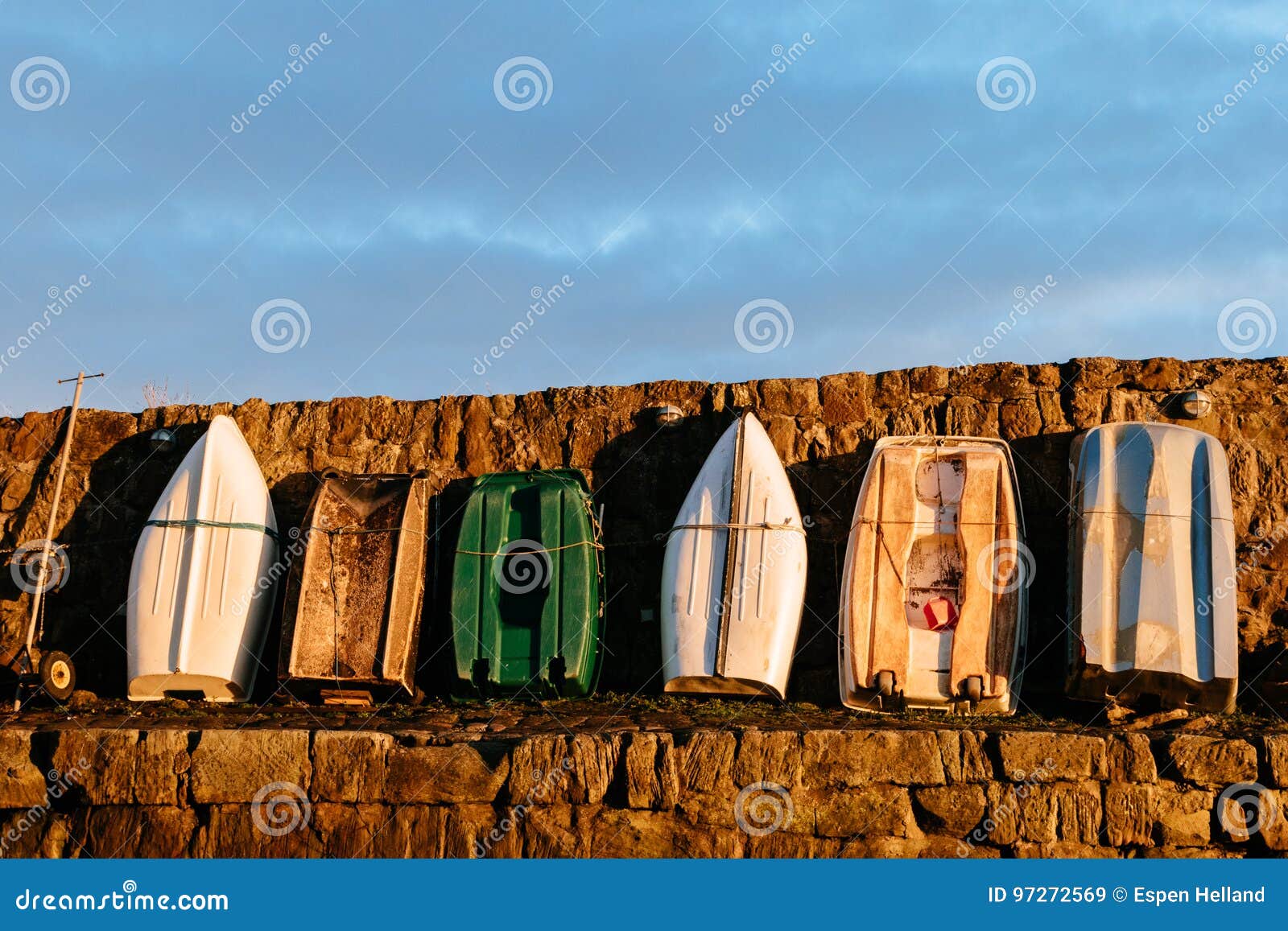 A Row of Rowing Boats Standing Upright on Land Stock Image - Image of ...
