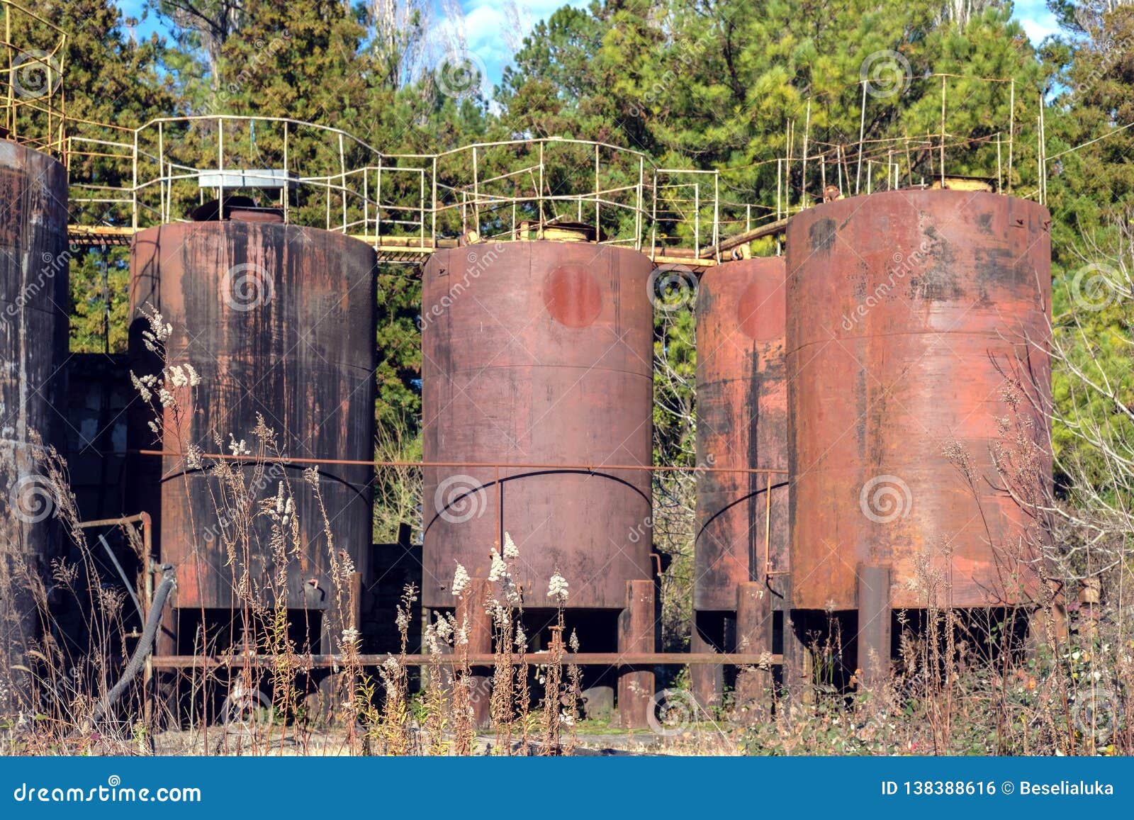 A row of rusty tanks stock photo. Image of line, factory - 138388616