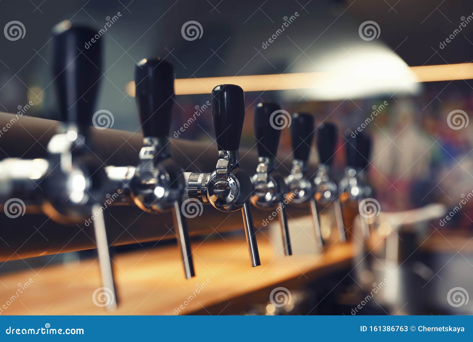 Row of shiny beer taps stock image. Image of natural - 161386763