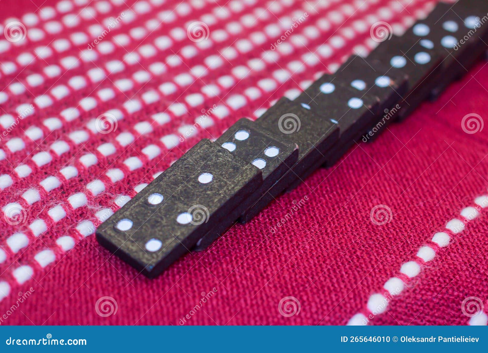 A Row of Stacked Dominoes on a Red Drapery Stock Photo - Image of game ...