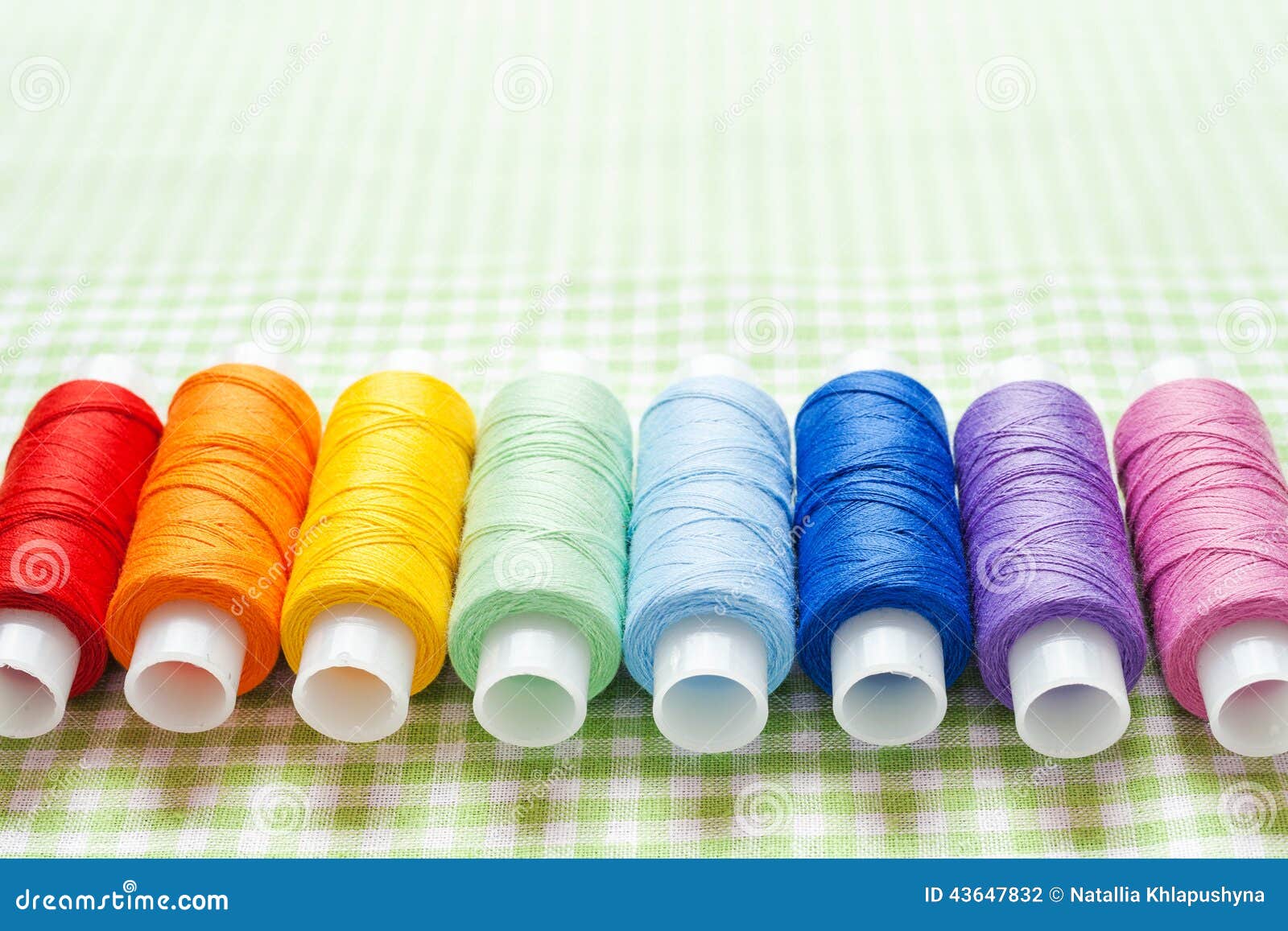 Row of Thread Spools in Rainbow Colors Stock Photo - Image of copyspace ...