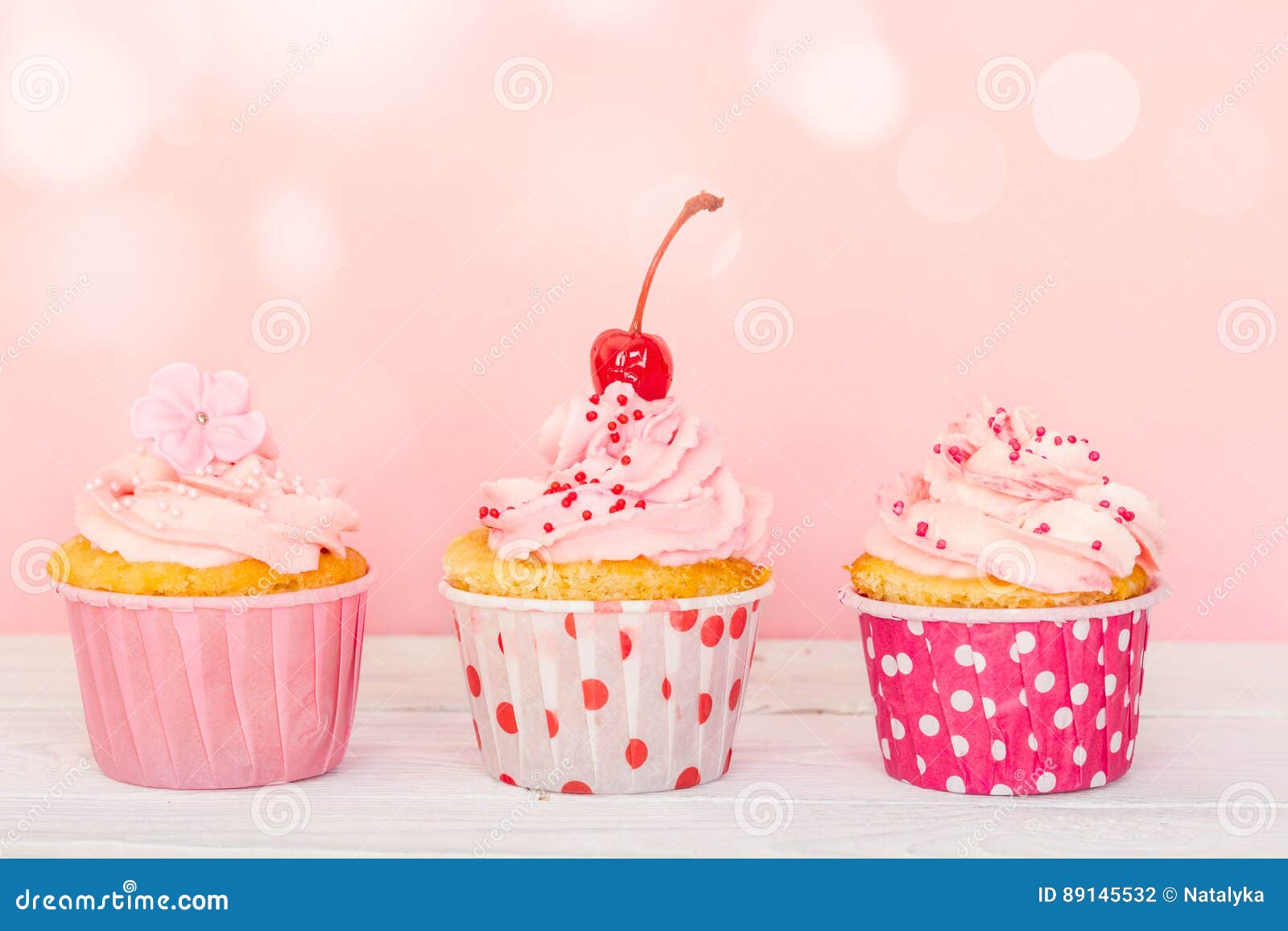 Row of Three Cupcakes with Cream and Decorations Stock Photo - Image of ...