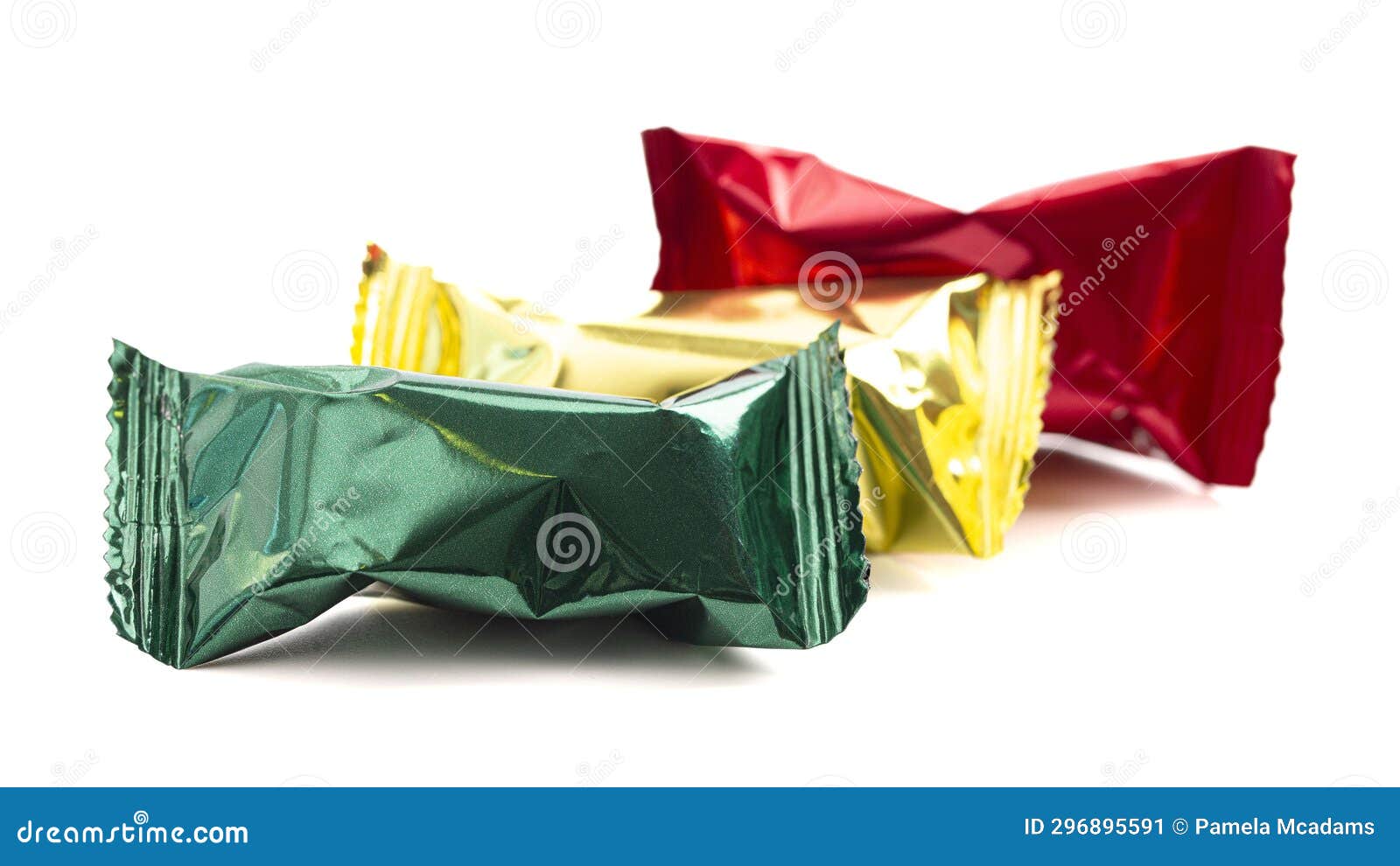 A Row of Three Foil Wrapped Chocolate Truffles Isolated on a White ...