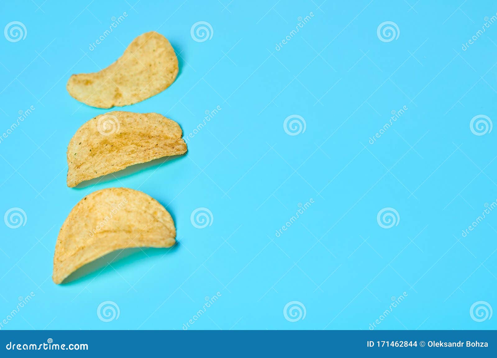 Row of Three Fried Potato Chips on Blue Background Stock Photo - Image ...