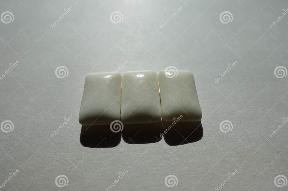 Row of Three White Pieces of Chewing Gum Stock Photo - Image of mouth ...
