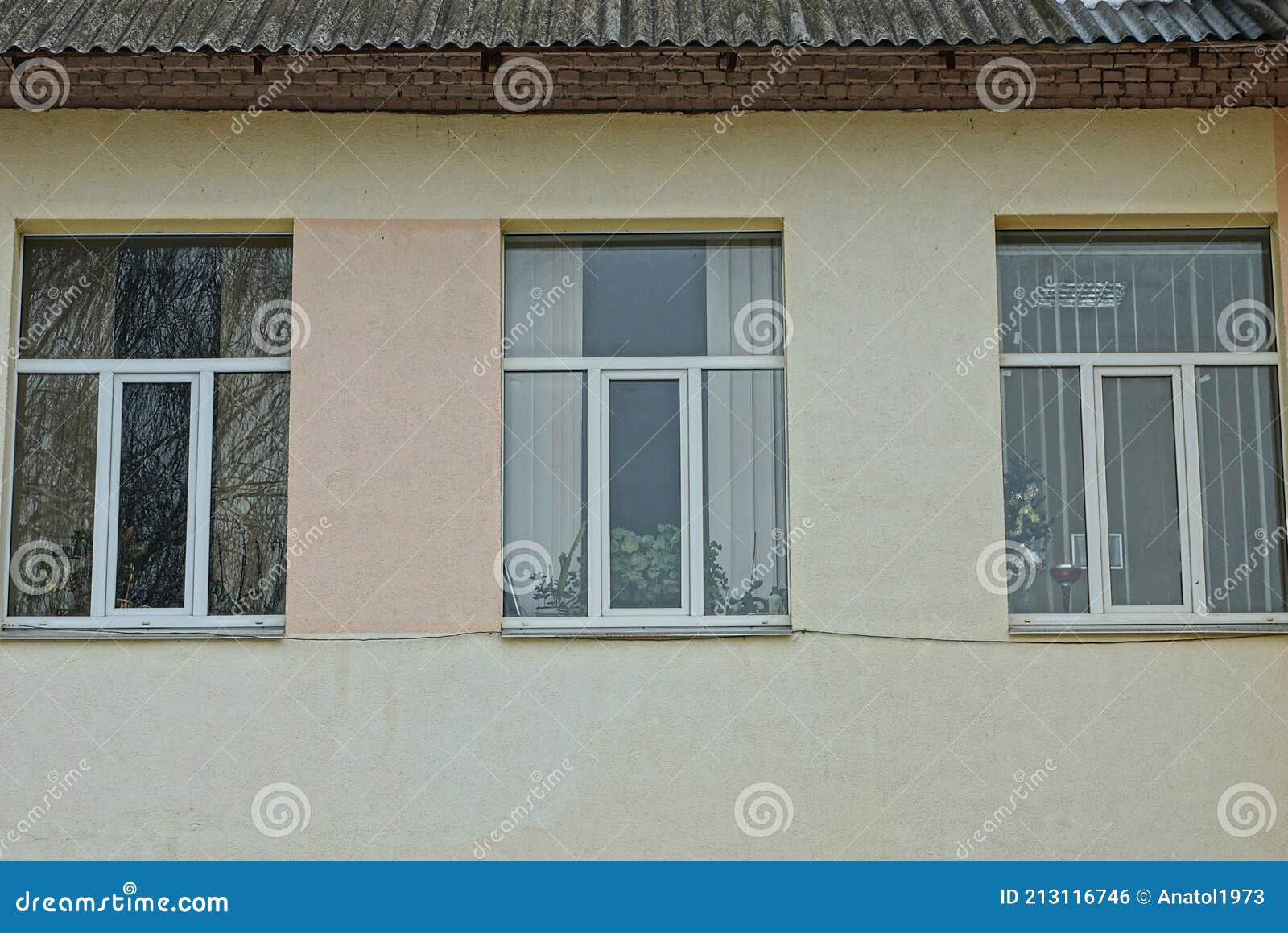 A Row of Three White Windows on a Brown Concrete Wall Stock Photo ...