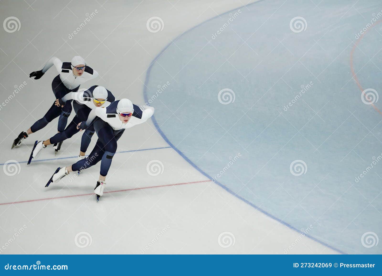 Row of Three Young Active Athletes on Skates Sliding Along Ice Rink ...