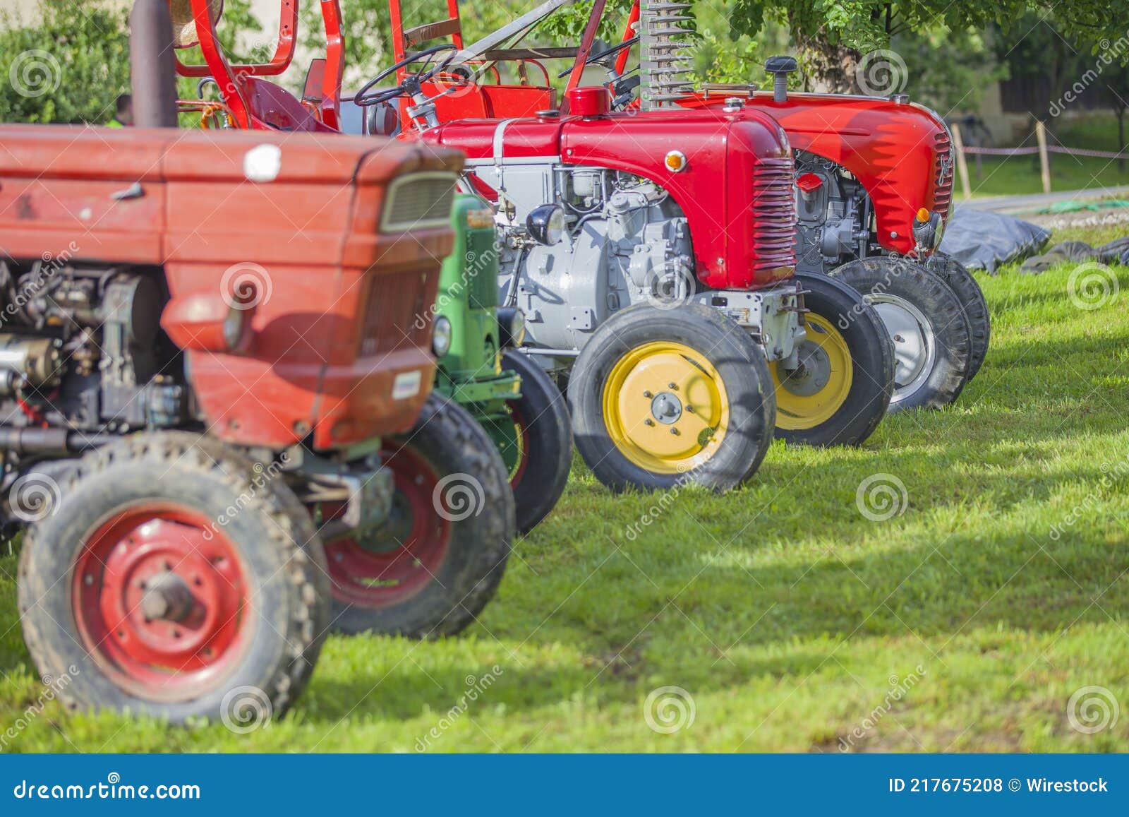 Row of tractors on a field stock photo. Image of rural - 217675208