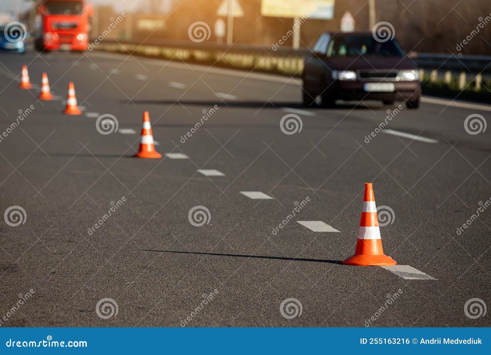 A Row of Traffic Orange Striped Cones on the Road. Sunlight Stock Photo ...