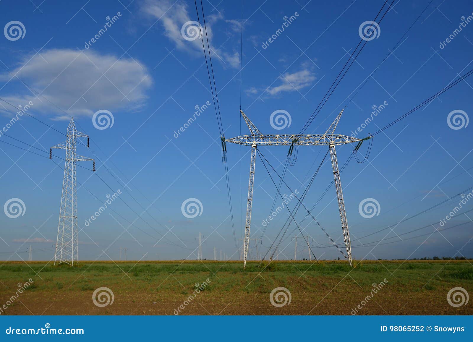 Row of Transmission Lines Against Blue Sky Stock Photo - Image of ...