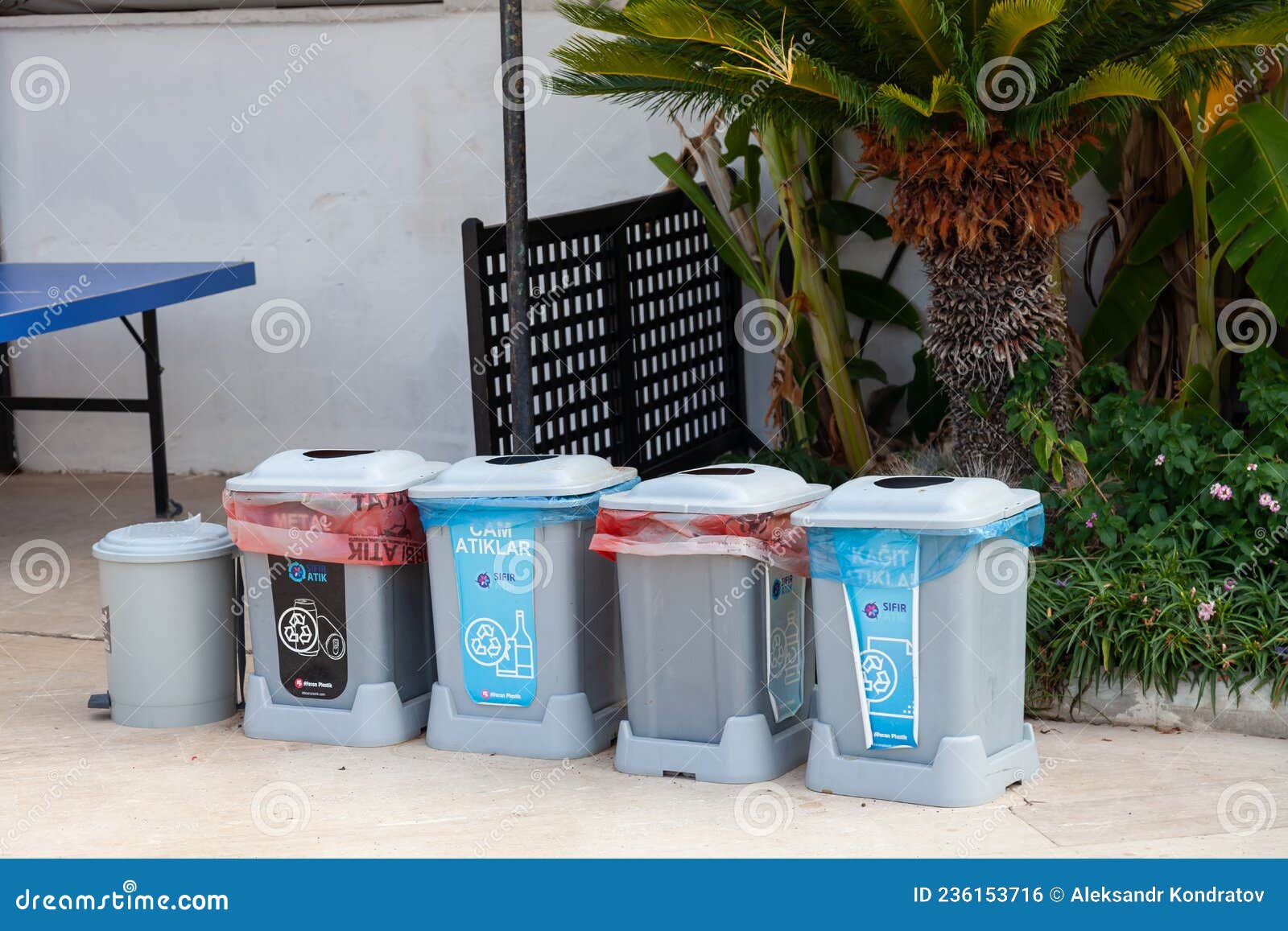 Row of Trash Cans for Sorted Garbage To Recycling. Environmental ...