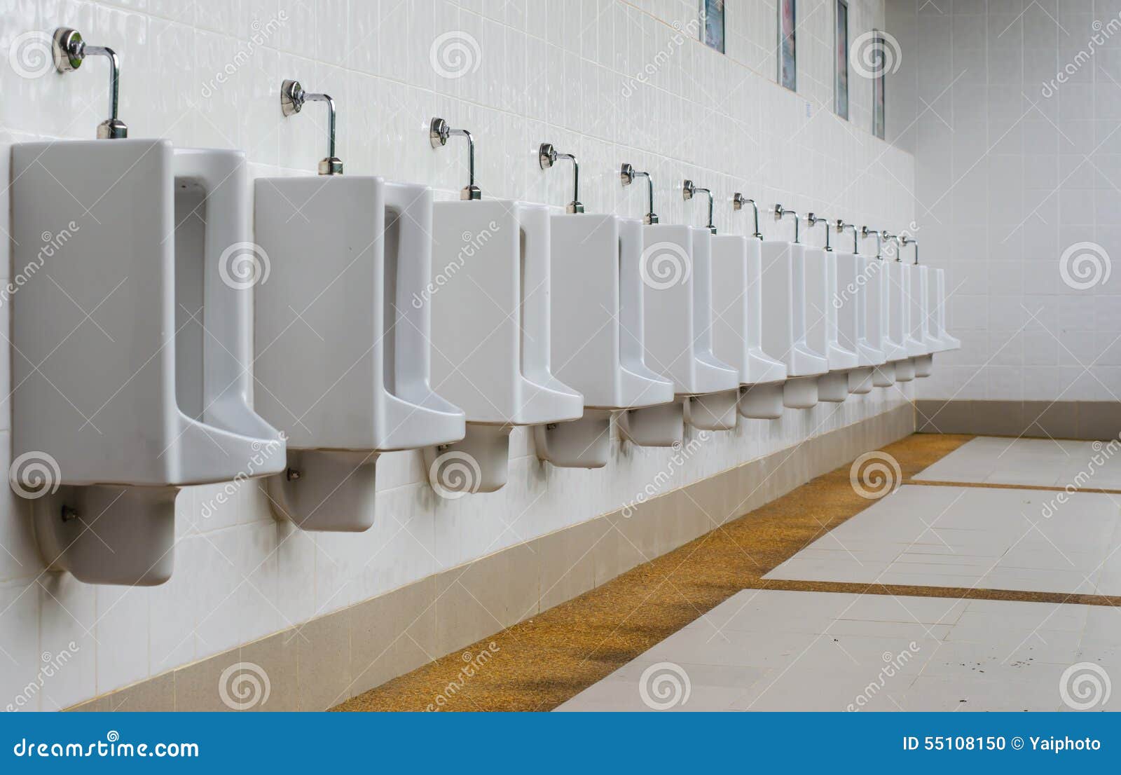 A Row of Urinals in Tiled Wall in a Public Restroom. Stock Photo ...