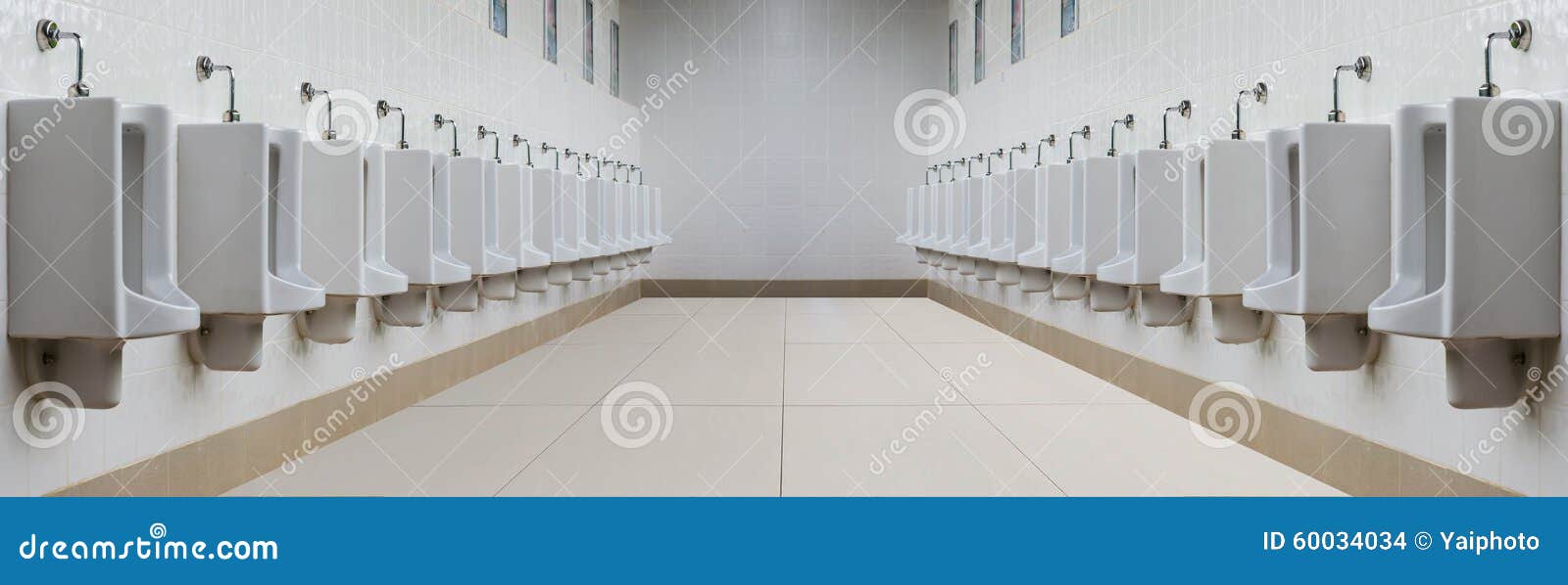 A Row of Urinals in Tiled Wall in a Public Restroom. Stock Photo ...