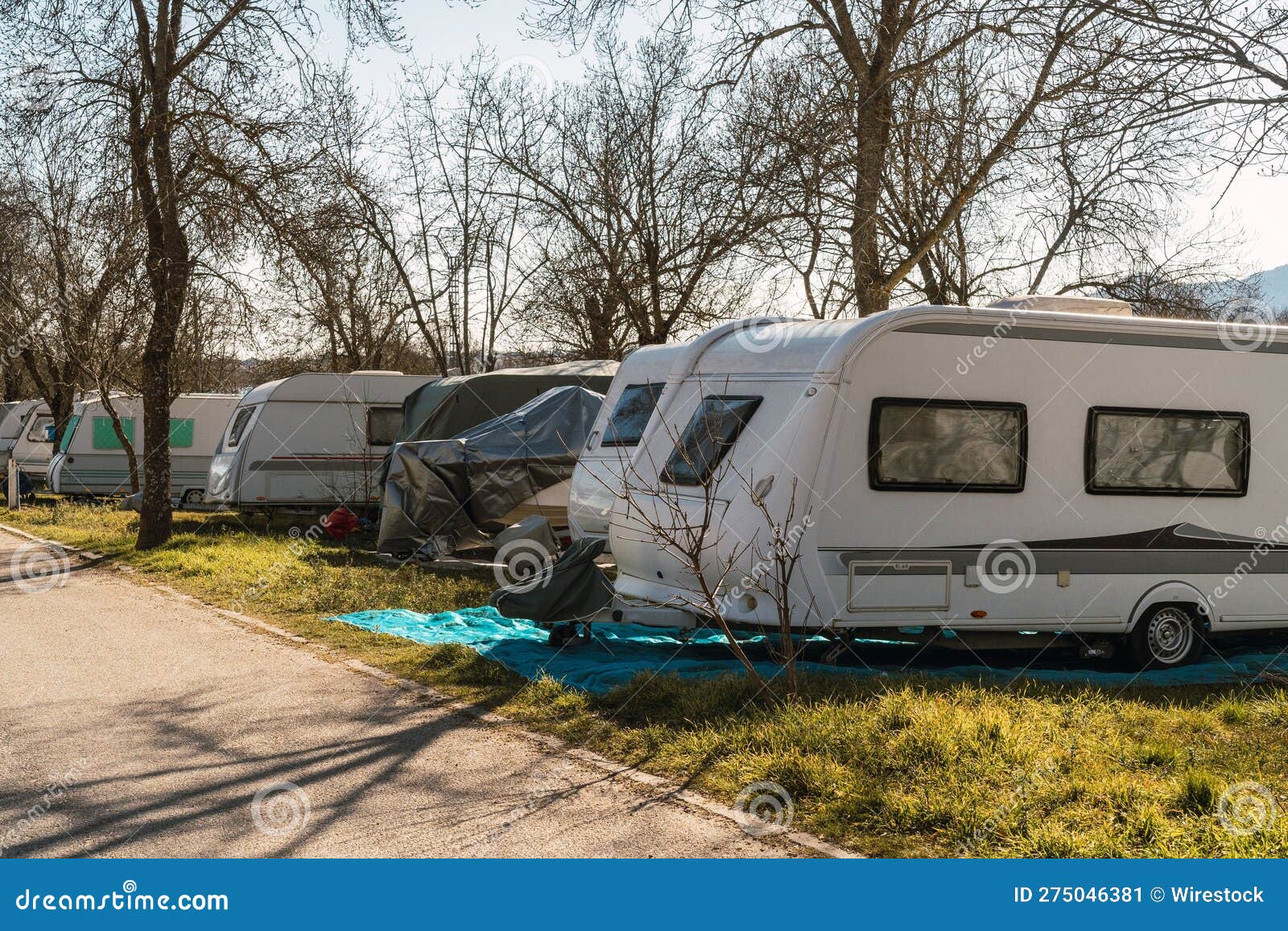 Row of Vehicles Parked in a Line Along a Roadside with Trees. Stock ...