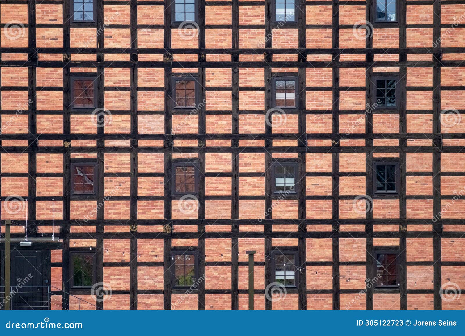 A Row of Vertical and Horizontal Windows in a Red Brick and Timber ...