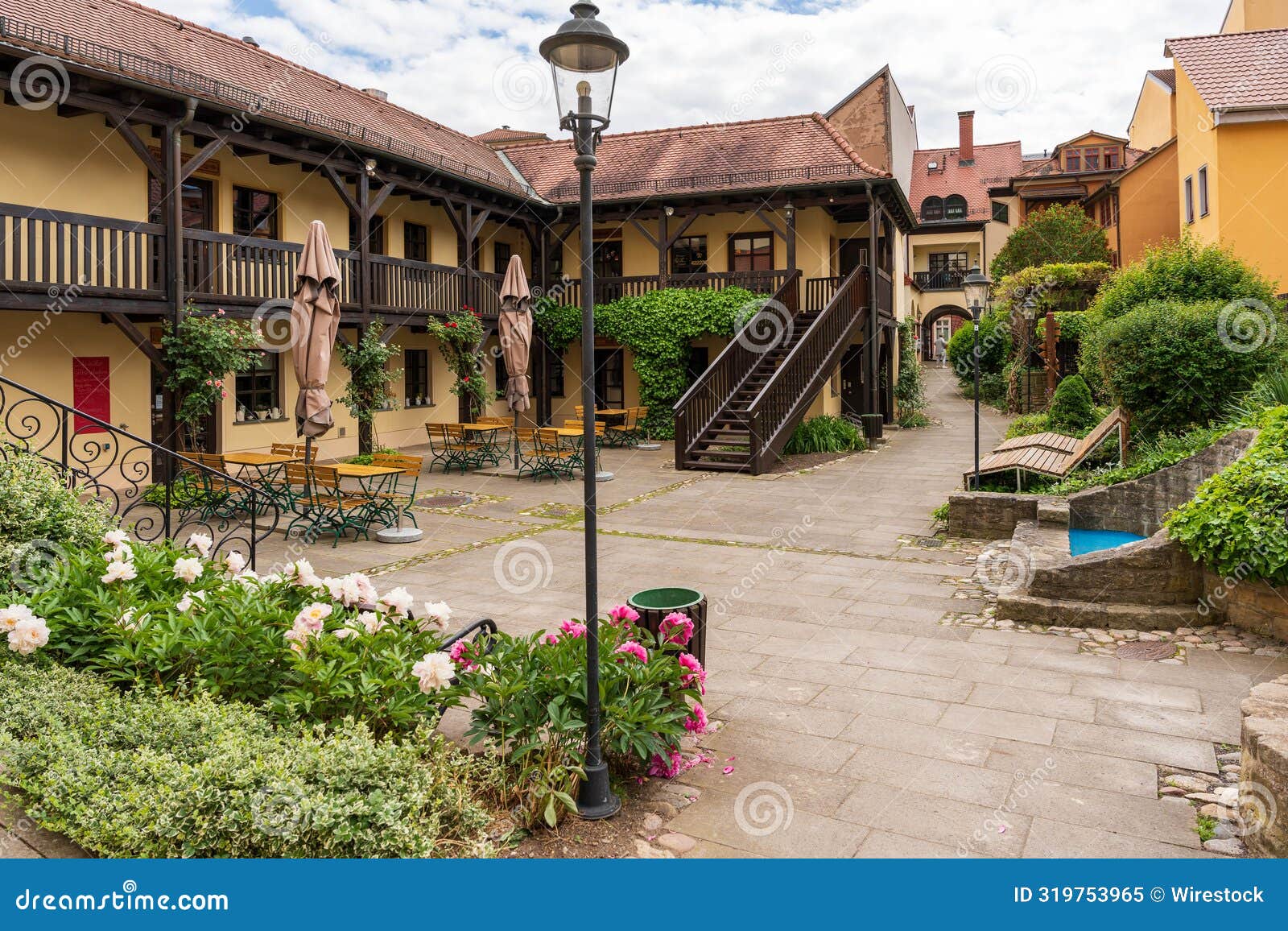 Row of Vintage Buildings with a Quaint Garden and Pathways in Front ...