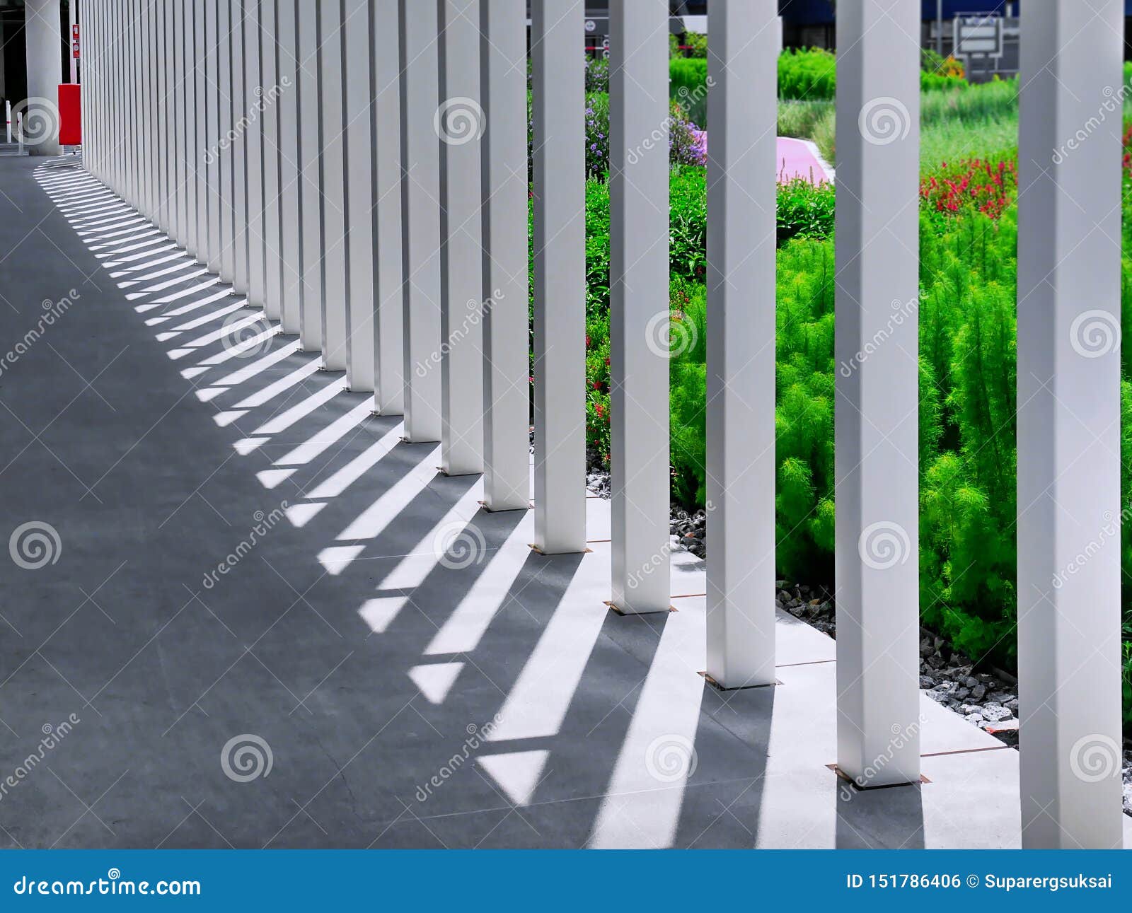 Row of White Square Pillars with Lights and Shadows on Walkway Stock ...