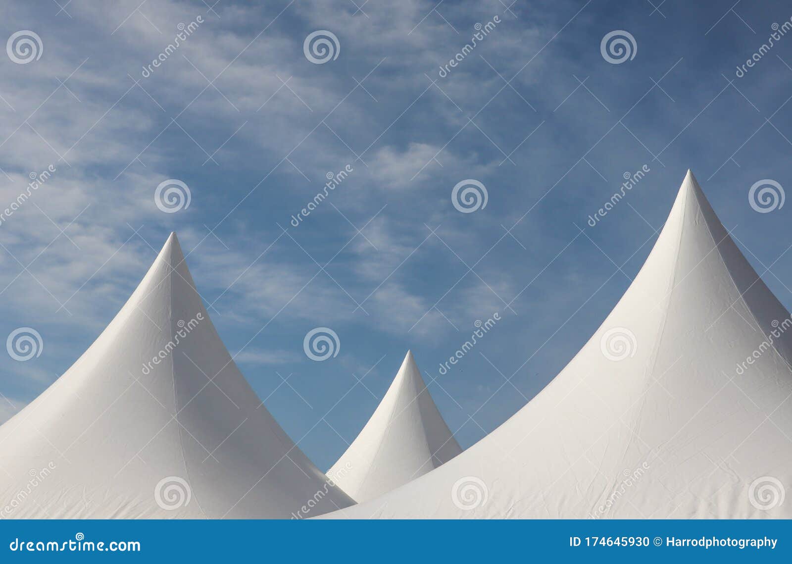 A Row of White Triangular Pyramid Marquee Rooftops Against a Blue Sky ...