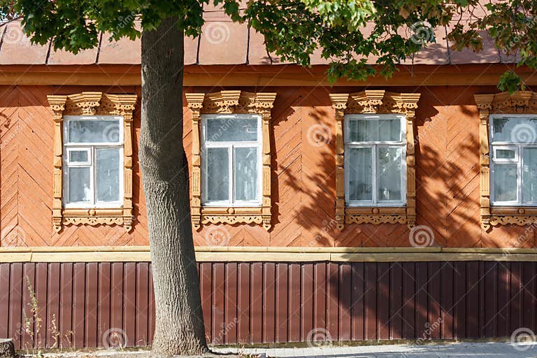 A Row of Windows on a Brown Building with a Tree in Front Stock Image ...