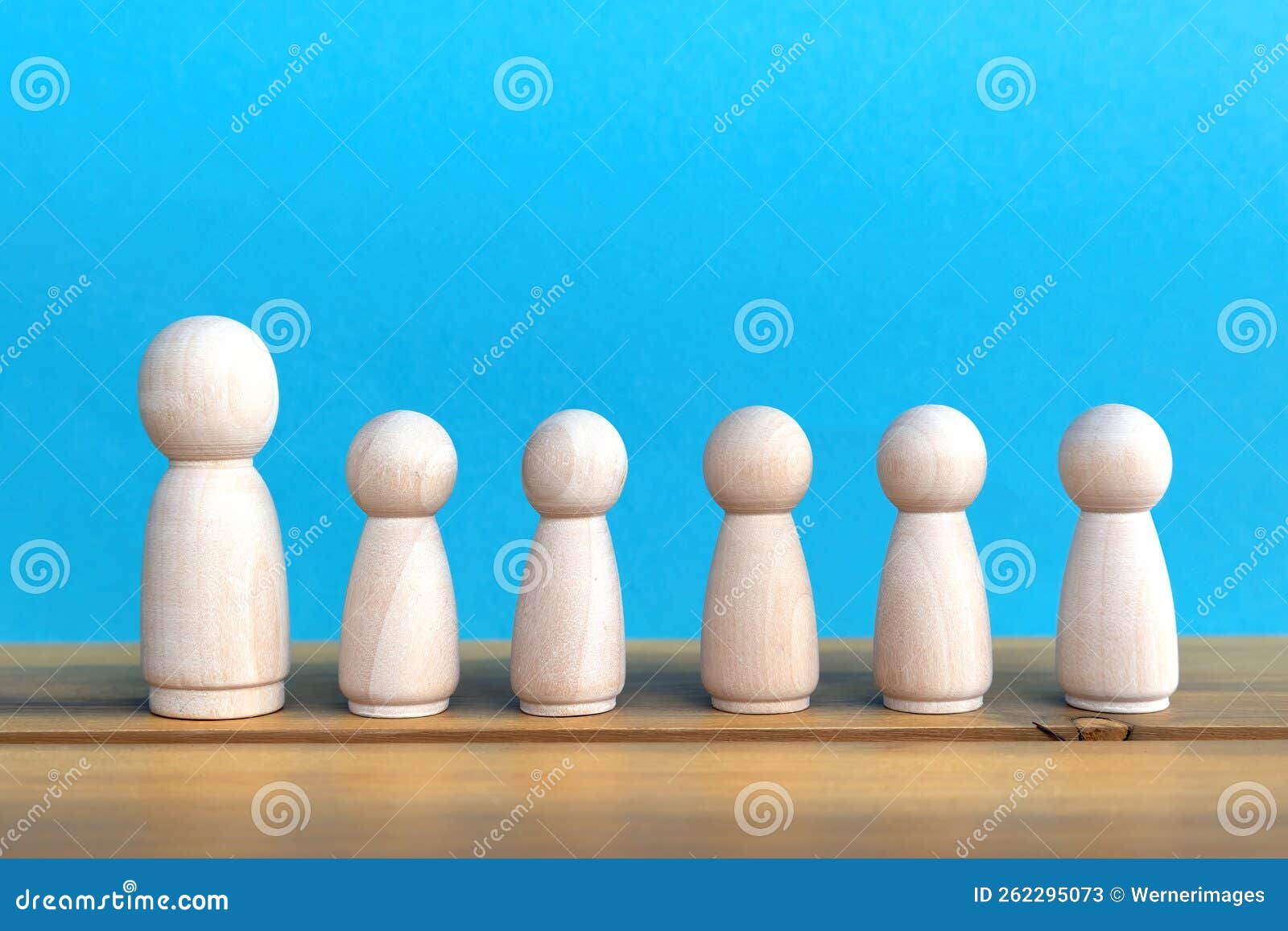 Row of Wooden Figures with One Bigger Then the Others Stock Image ...