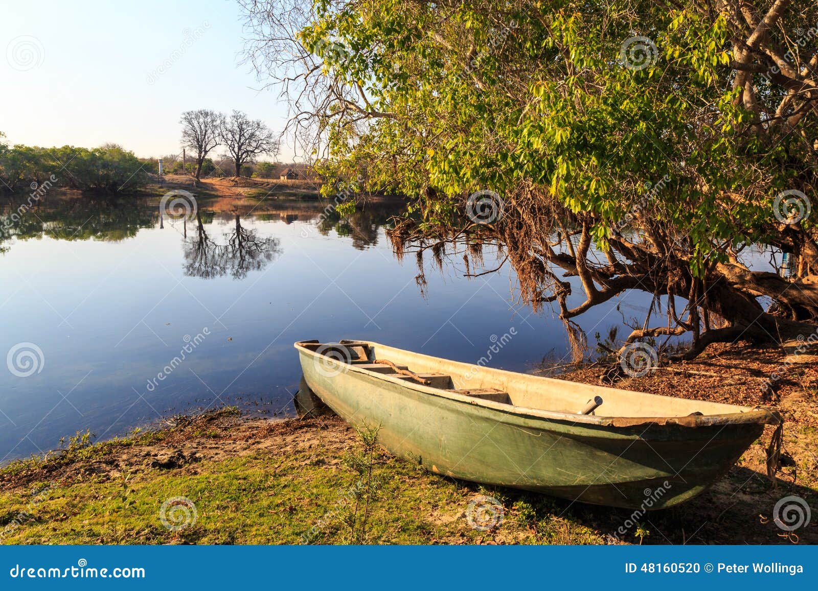Rowing Boat Lying on the Banks of a River Lit by Sun Stock Photo ...