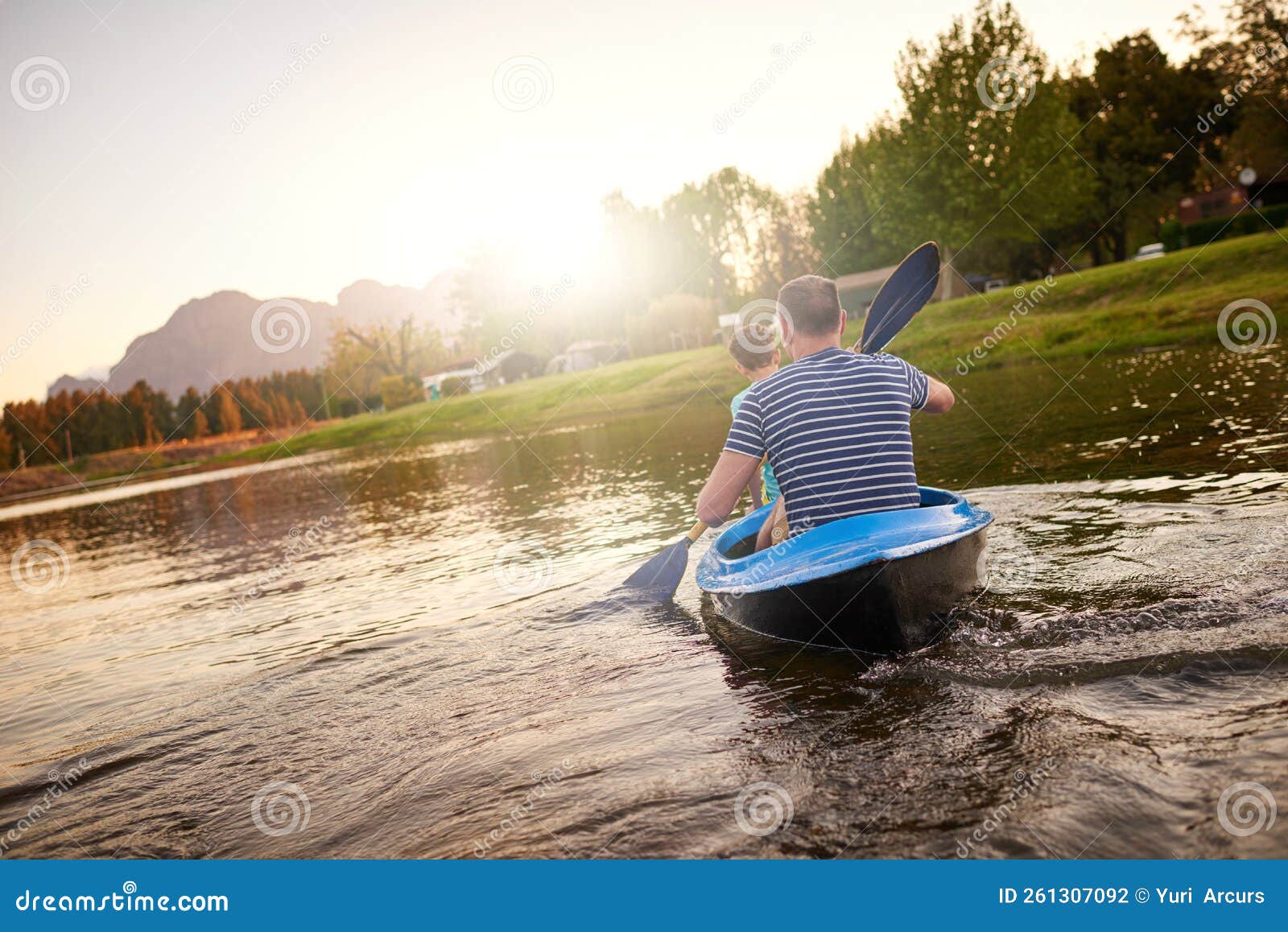 Rowing into the Sunset. a Father and Son Rowing a Boat Together on a ...