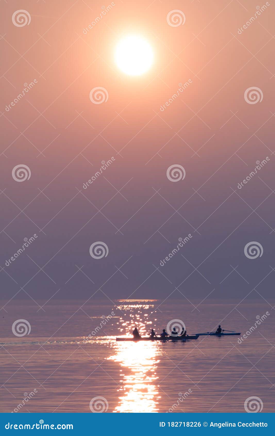 Rowing Team Training with Trainer Over Shimmering Lake at Sunset Stock ...