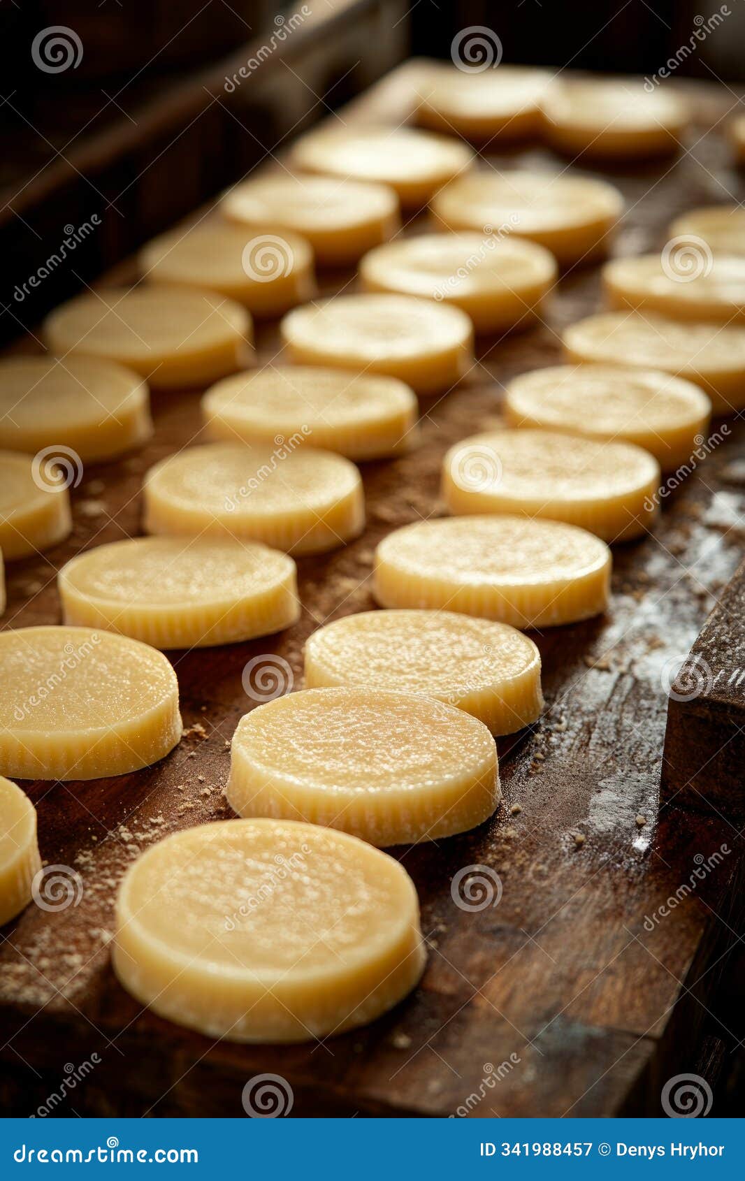 Rows of Artisan Cheese Wheels Rest on a Wooden Board in a Rustic ...