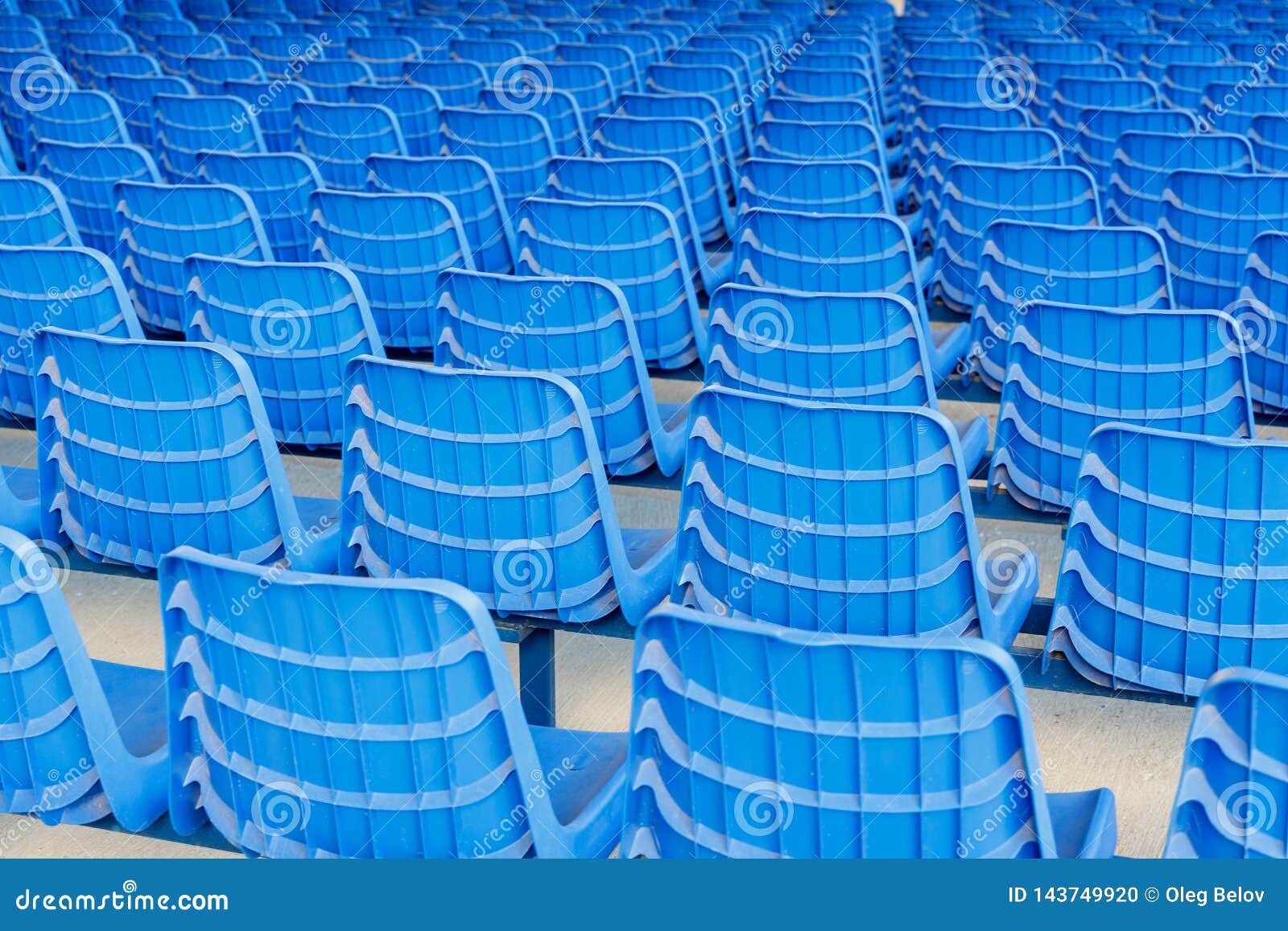 Rows of Blue Plastic Chairs on a Metal Base. Back View Stock Photo ...