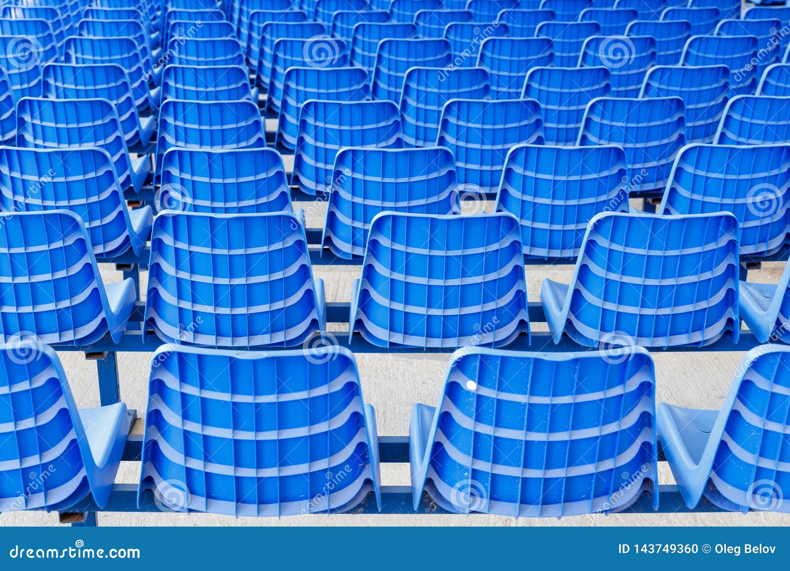Rows of Blue Plastic Chairs on a Metal Base. Back View Stock Photo ...