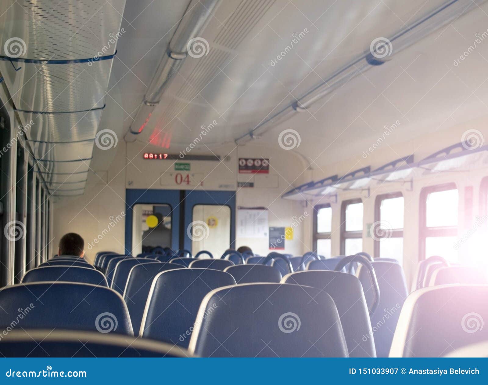Rows of Blue Soft Seats in a Passenger Train Car. Bright Sun Shines ...