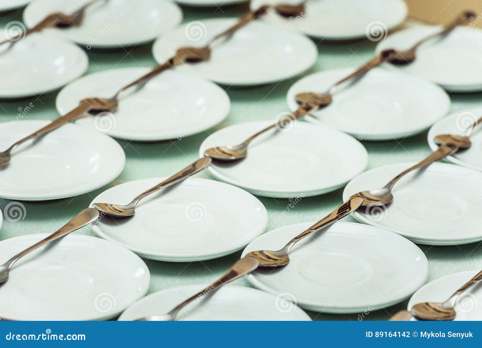 Rows of Clean White Dish and Spoon in a Cafeteria or Restaurant Ready ...