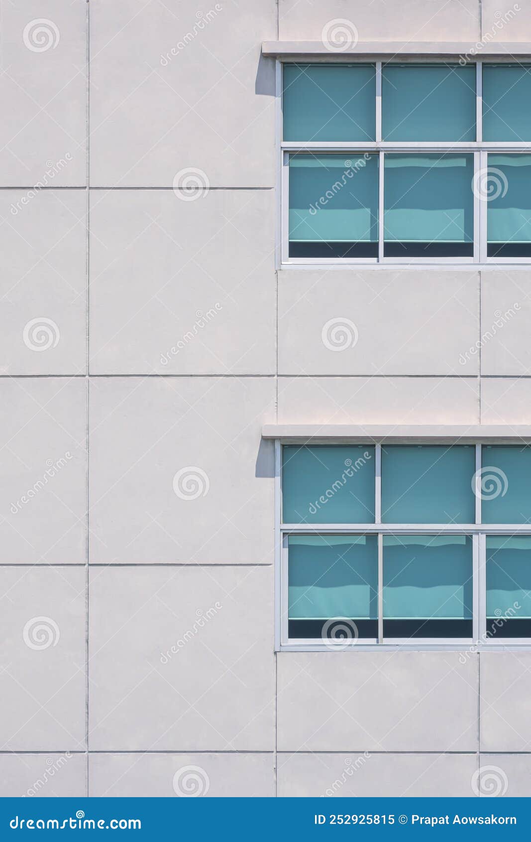 2 Rows of Glass Windows on Large Square Concrete Tiles Wall of Office ...