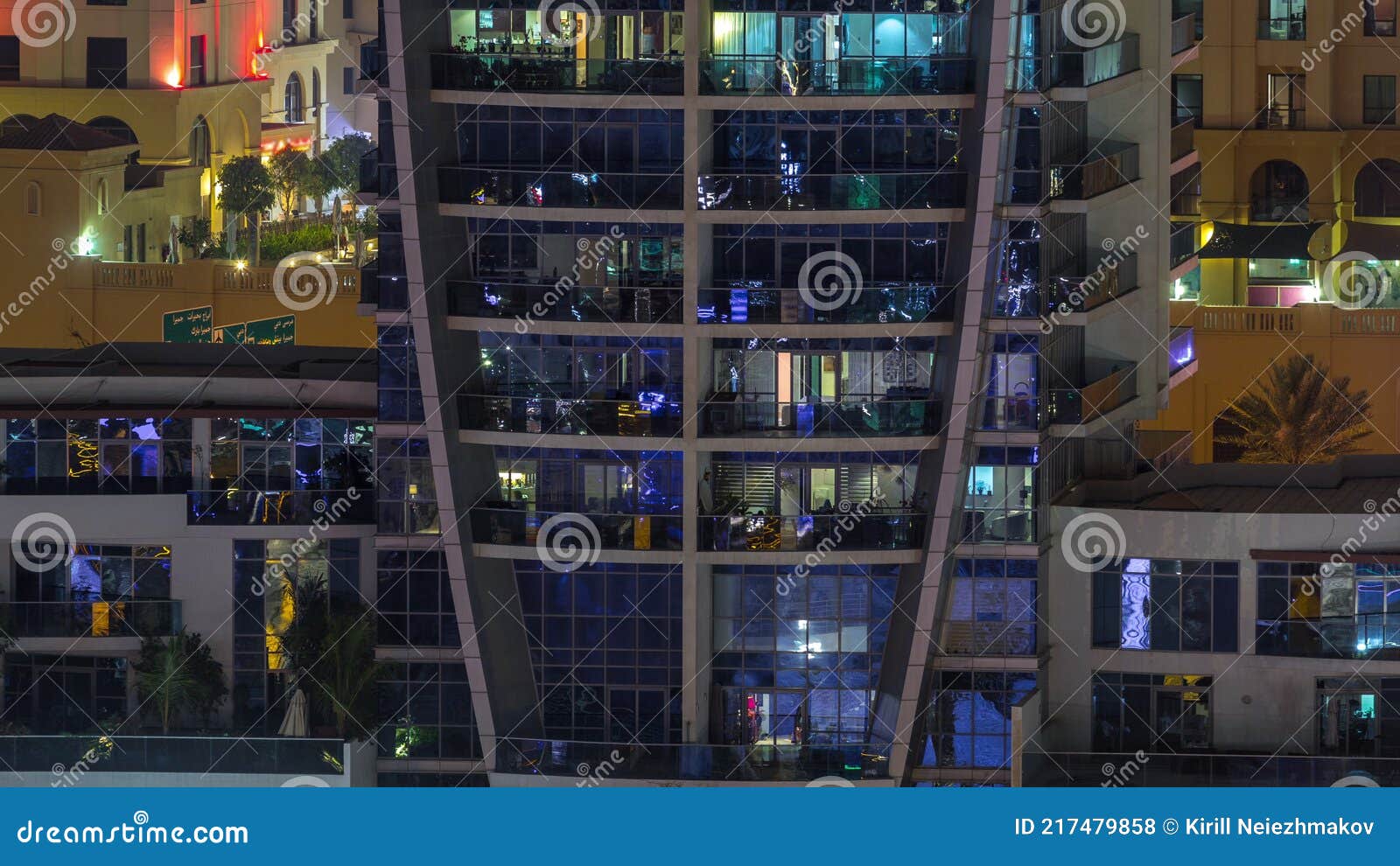 Rows Of Glowing Windows With People In Apartment Building At Night ...