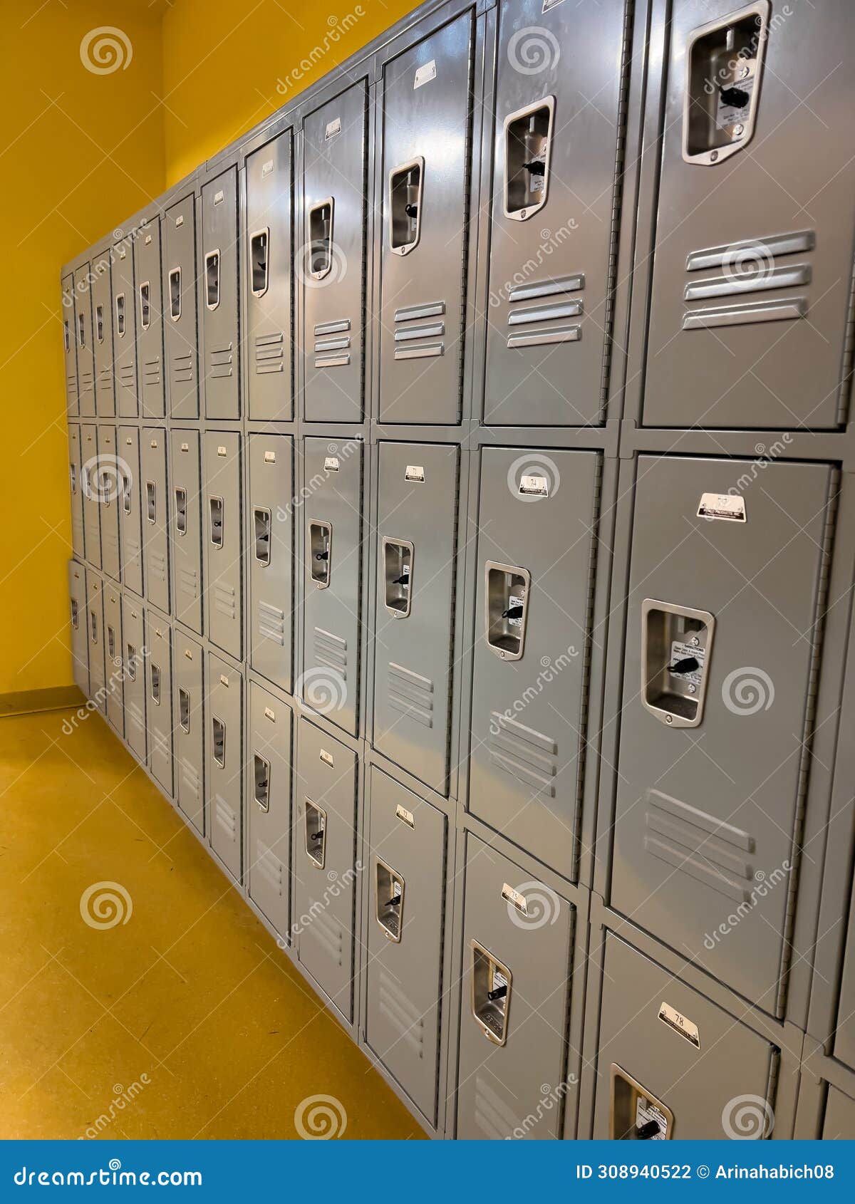 Rows of Gray School Lockers Lined Up Against a Yellow Wall Stock Photo ...