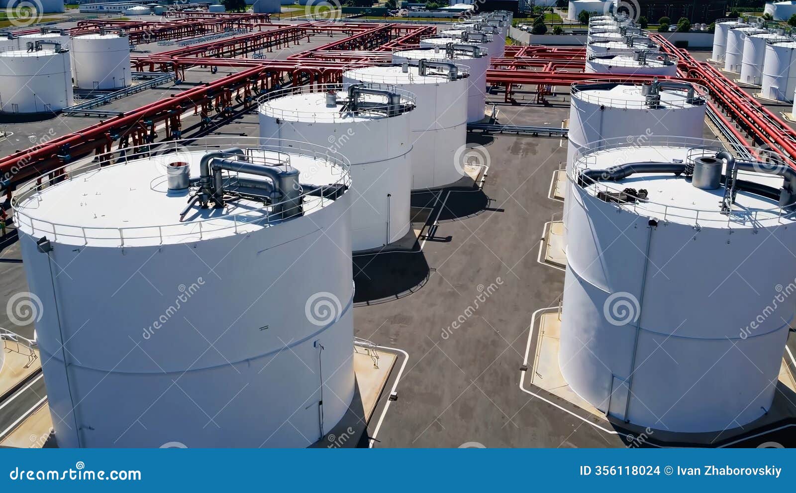 Rows of Large White Cylindrical Fuel Storage Tanks at a Refinery or ...