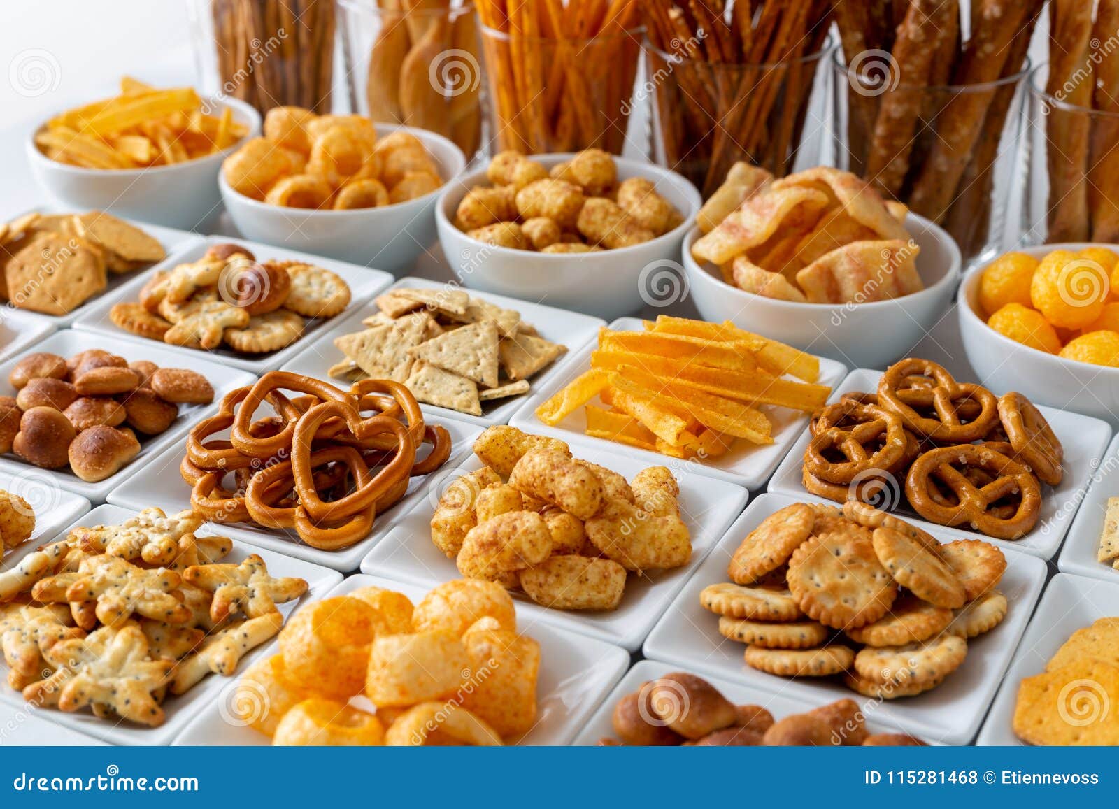 Rows of Many Types of Savory Snacks in White Ceramic Dishes. Stock ...
