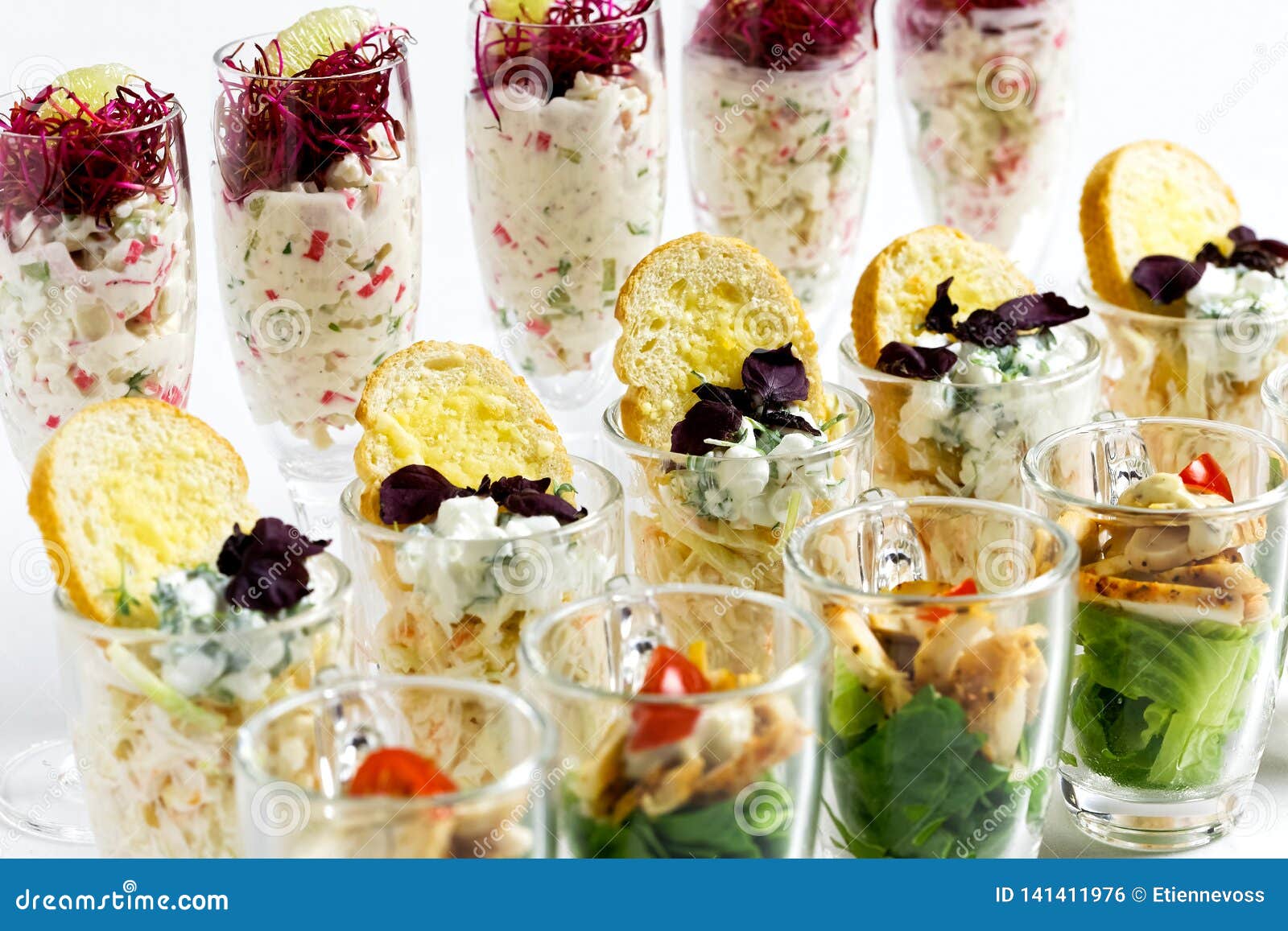 Rows of Modern Canapes in Flute Glasses and in Glass Mugs Stock Photo ...