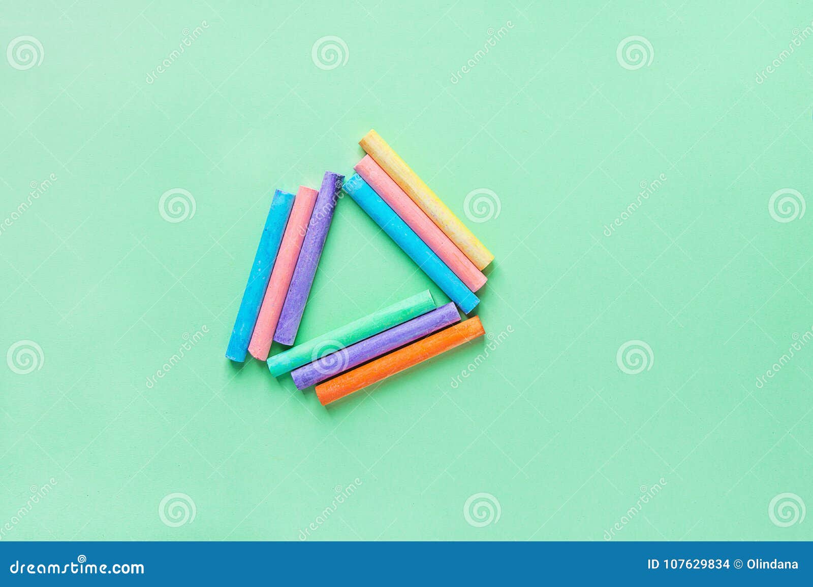 Rows Of Multicolored Chalks Crayons Arranged In Triangle On Turquoise ...