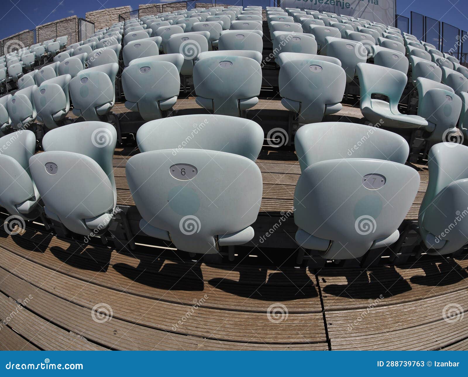 Rows of Numbered Empty Plastic Seats at an Open-air Amphitheater. Many ...