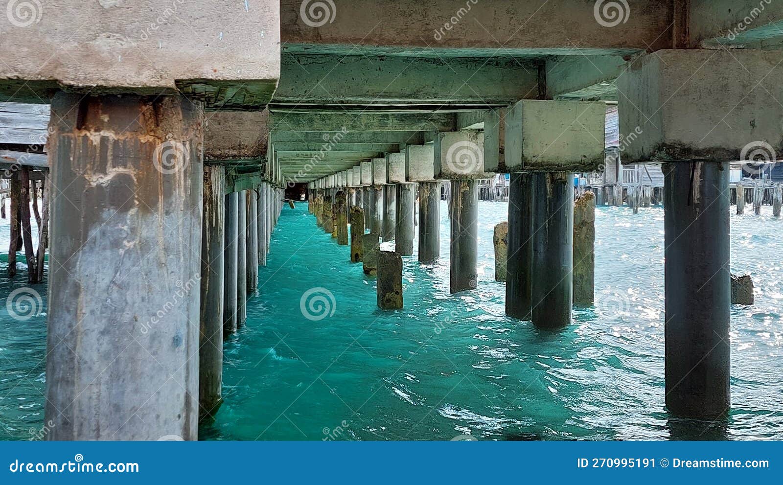 Rows of Pillars Supporting the Bridge and Blue Sea Water. Stock Image ...