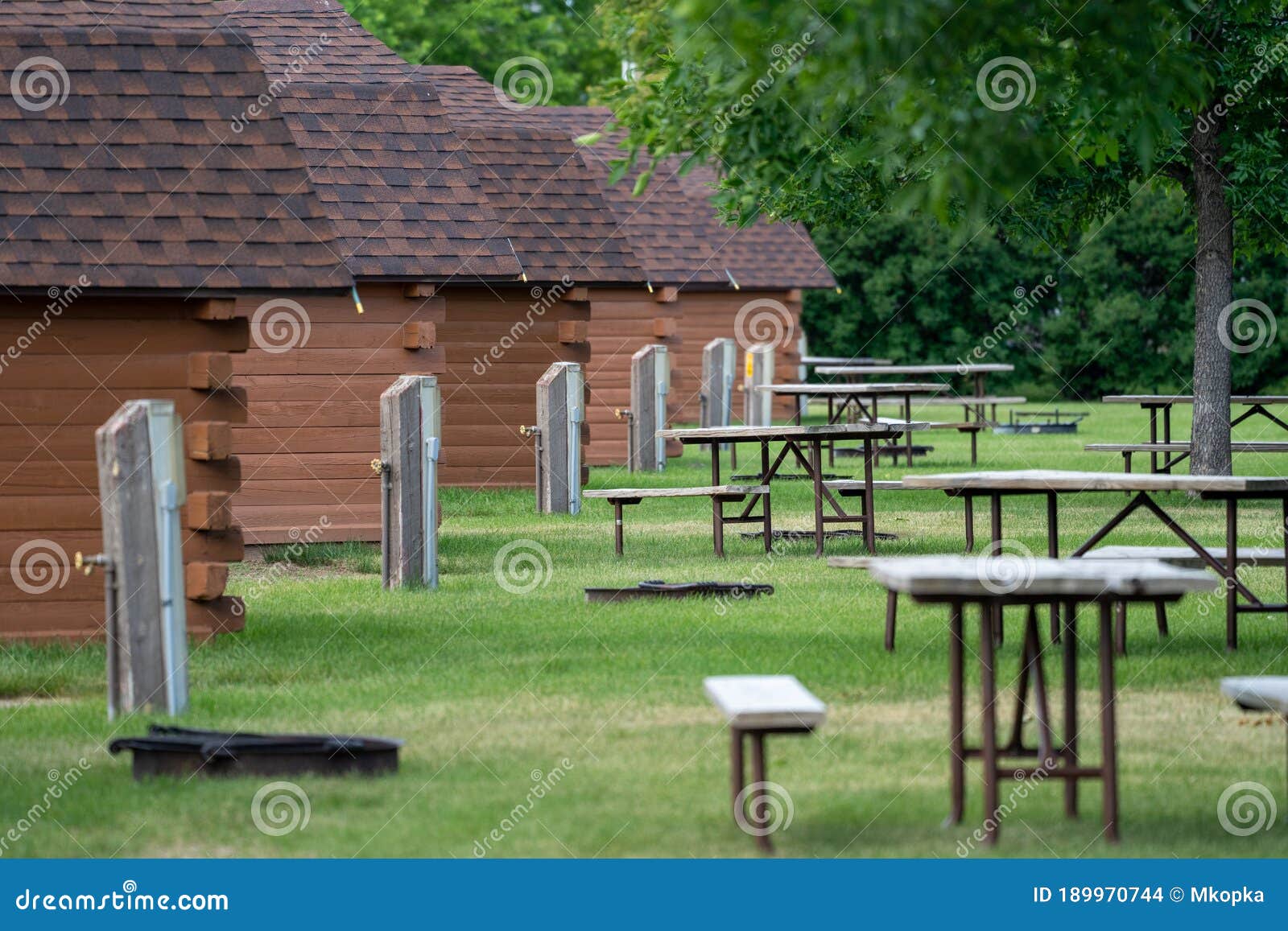 Rows of Rustic Camping Cabins, with Water Pumps and Picnic Tables at a ...