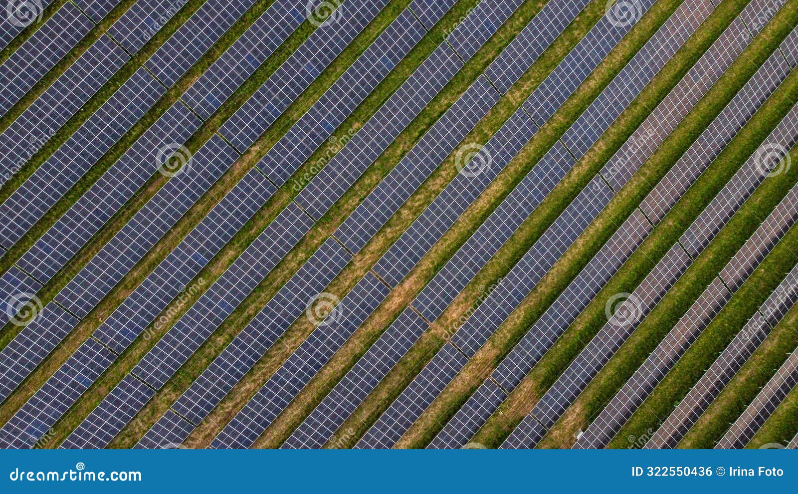 Rows of Solar Panels with a Green Landscape Background Stock Photo ...